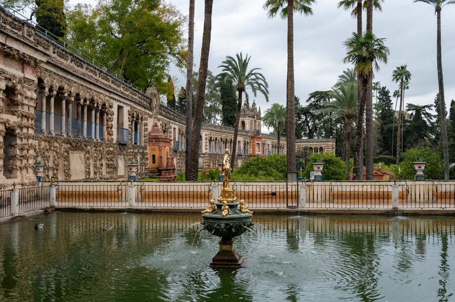 Royal gardens with lush trees at Alcazar Seville