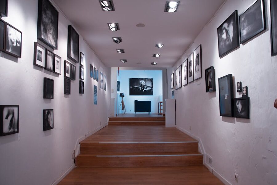 Modern gallery corridor with framed pictures lining white walls