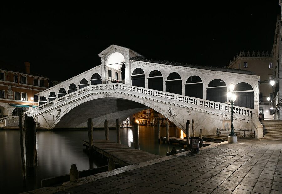 Rialto Bridge illuminated at night in Venice