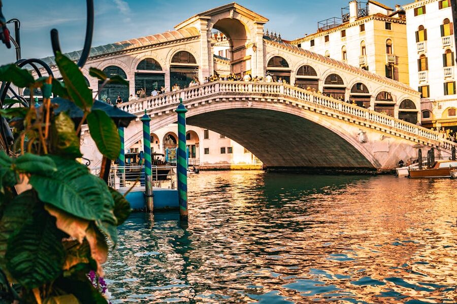 Rialto Bridge at sunset with canal reflections