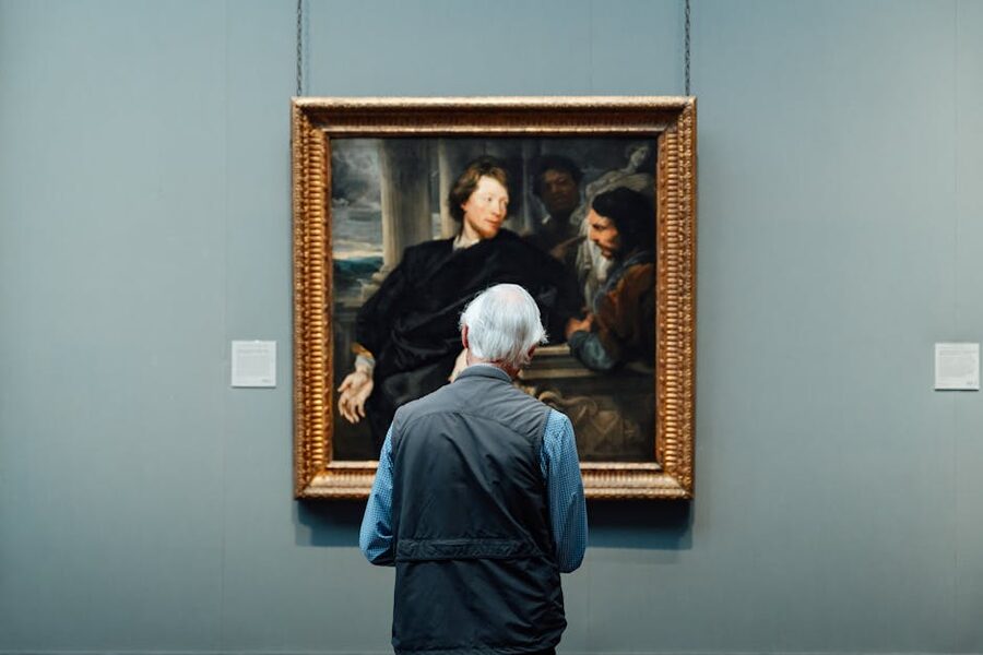 Visitor admiring a classical painting in an art gallery