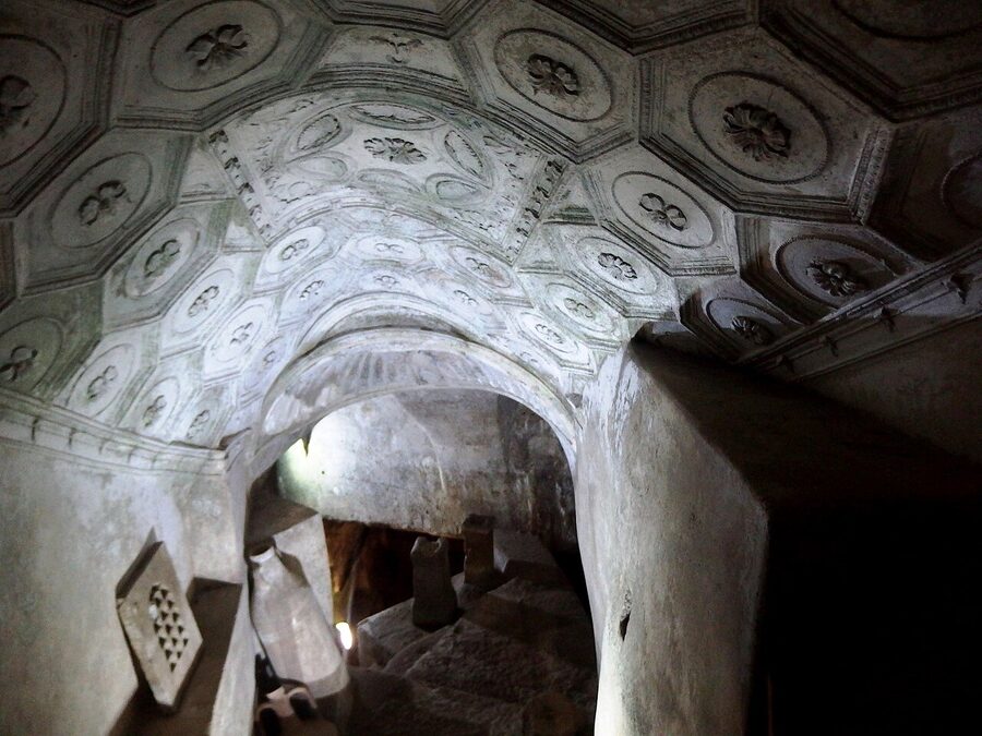 Stone walls and arched ceiling inside Catacombs of San Sebastiano