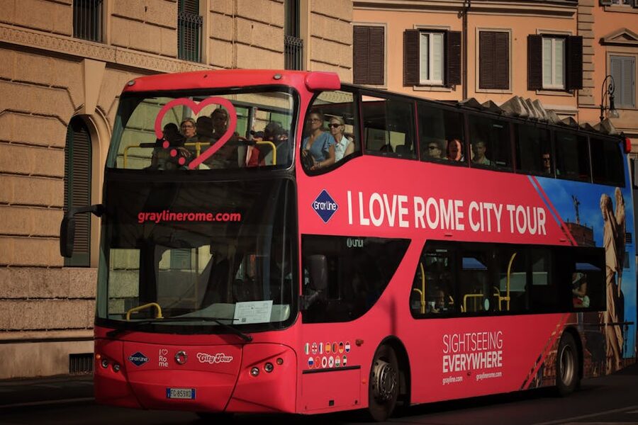 Open-top hop-on hop-off bus interior in Rome with passengers