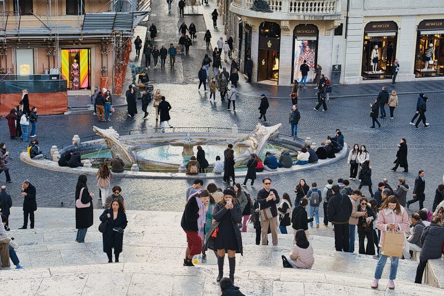 Piazza di Spagna Rome with the Barcaccia Fountain and crowd