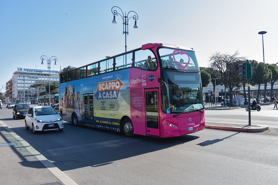 Hop-on hop-off bus passing Piazza Venezia in Rome