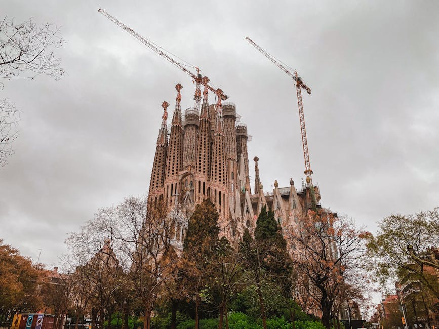 Sagrada Familia under construction with cranes in Barcelona