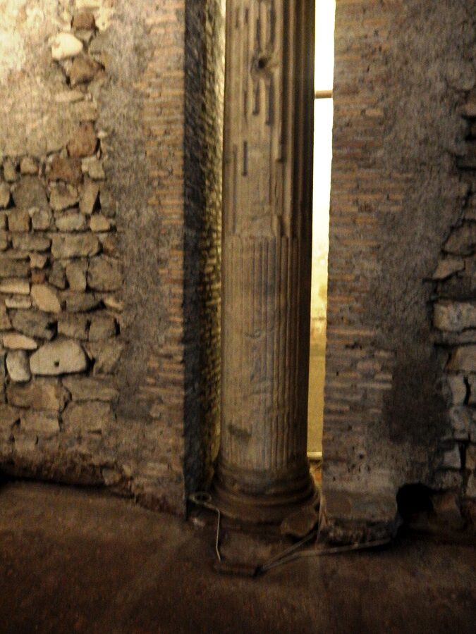 San Clemente lower basilica column with fresco Rome