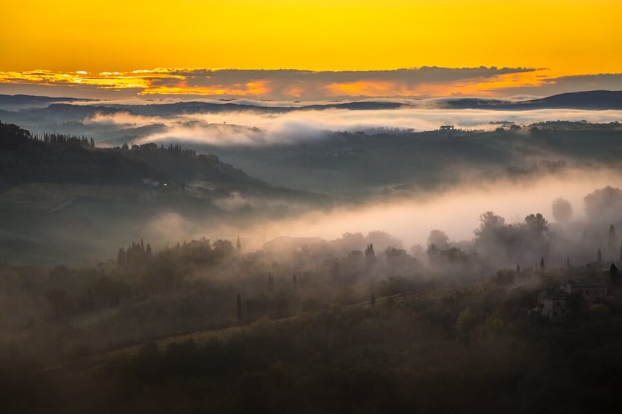 Sunrise over fog-covered Tuscan hills around San Gimignano