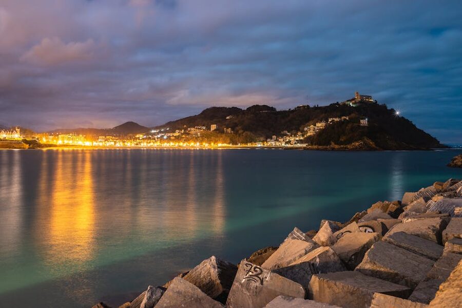 San Sebastián coastline lit up at night with reflections on the bay