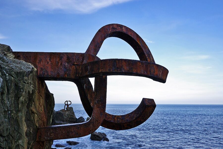 Peine del Viento Chillida steel sculpture mounted on rocks at the end of La Concha