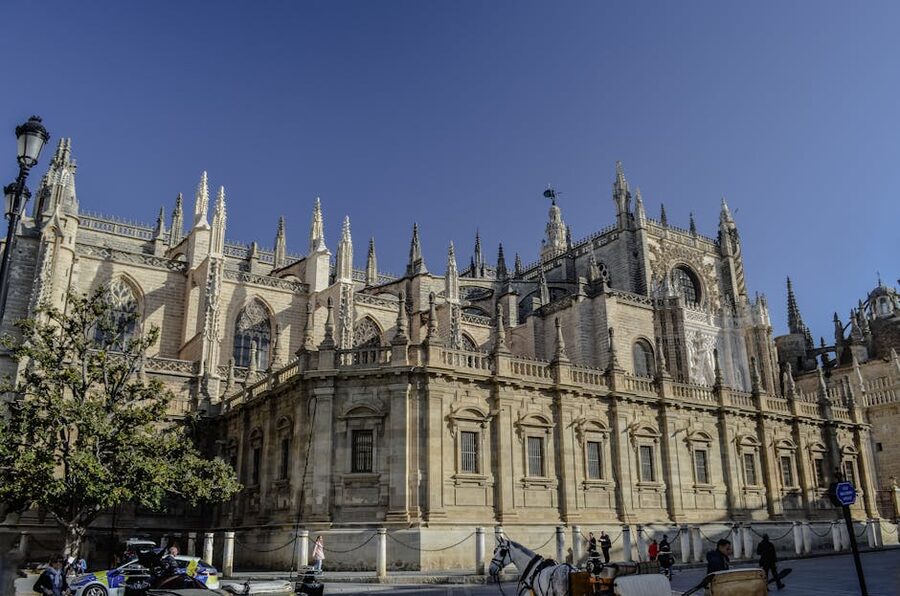 Seville Cathedral with horse-drawn carriage near the bike tour route