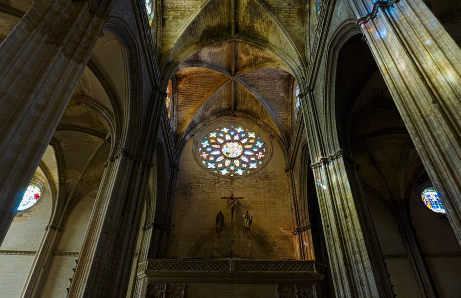 Seville Cathedral interior with gothic columns and stained glass