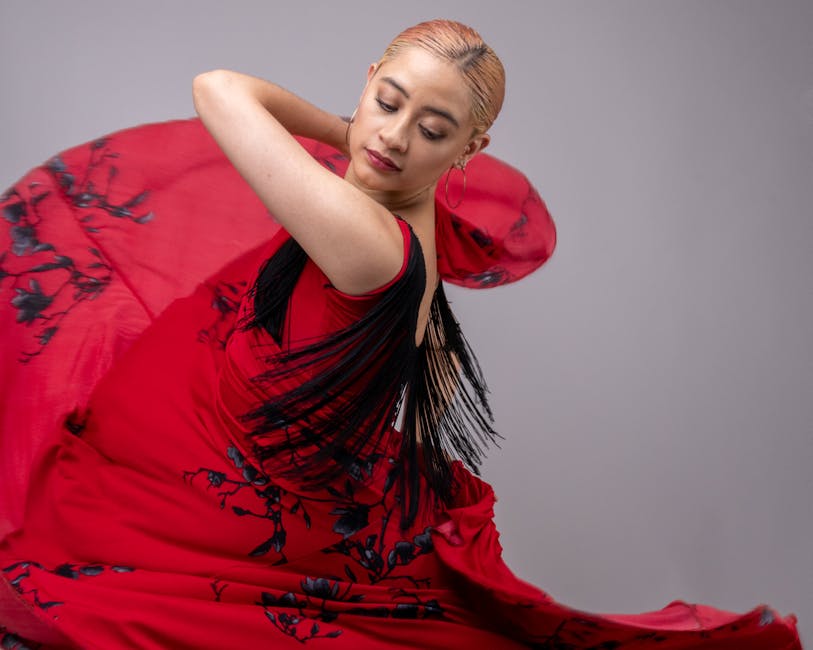 Flamenco dancer in a red dress mid-spin