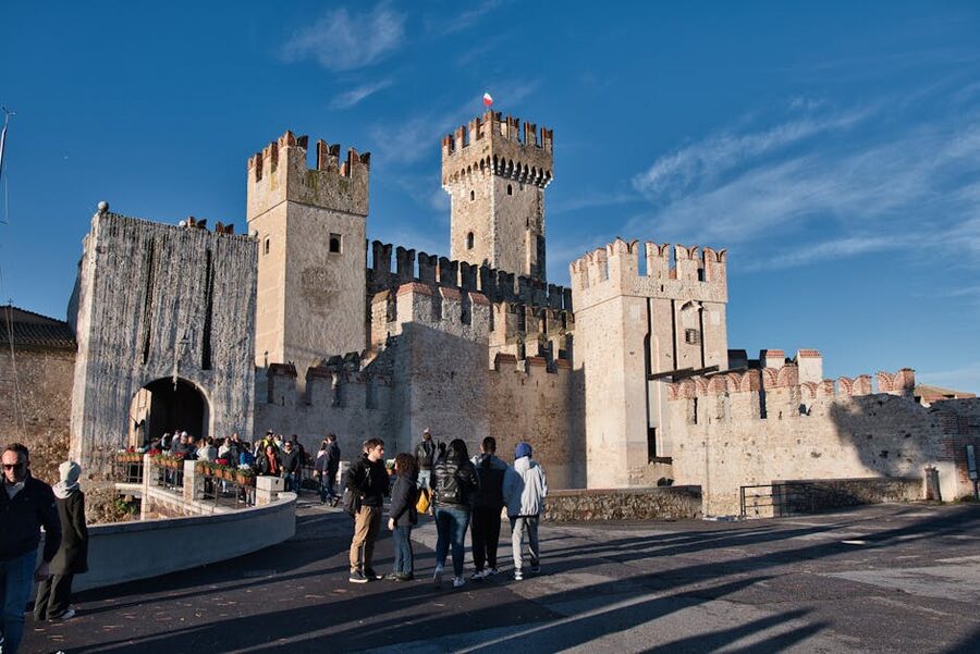 Tourists exploring Scaliger Castle in Sirmione