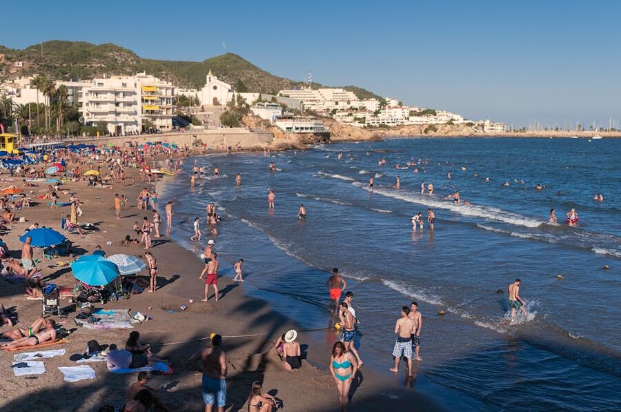 People enjoying Sitges beach on a summer day