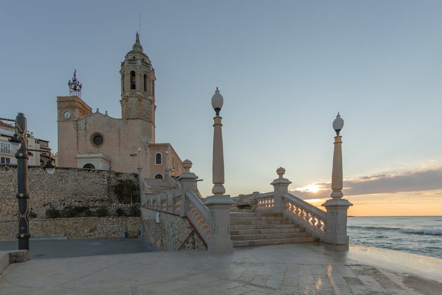 Sitges church above the seafront promenade at sunrise