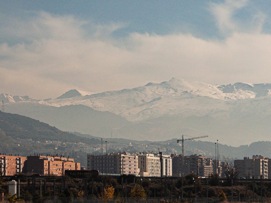 Granada city skyline with snow capped Sierra Nevada mountains behind