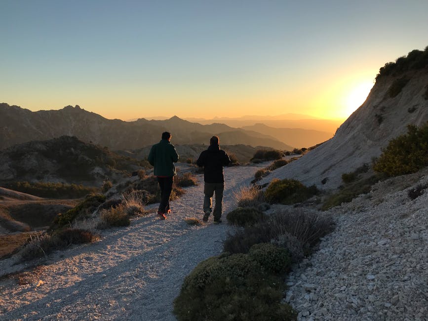 Two hikers walking trail in Sierra Nevada Spain at sunrise