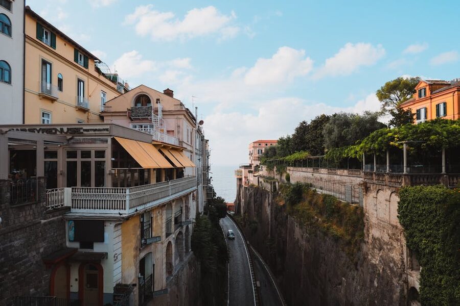 A Sorrento street with traditional architecture and a glimpse of the sea