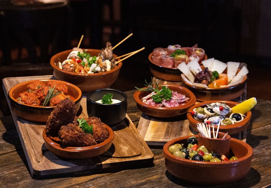 Assorted Spanish tapas on rustic wooden table