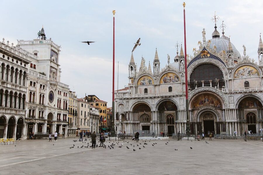 Tourists and pigeons in Piazza San Marco in front of St Marks Basilica
