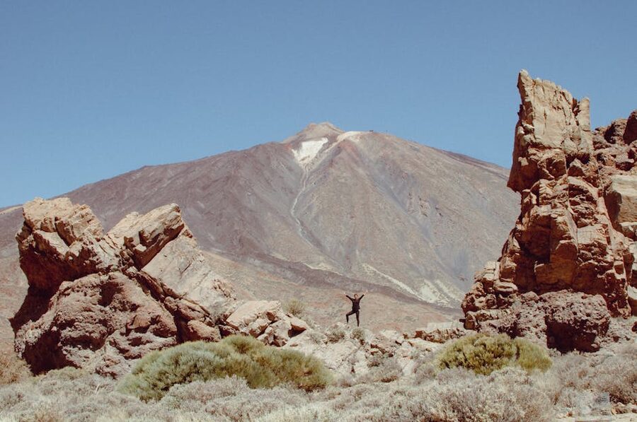 Hiker among volcanic rocks at Mount Teide