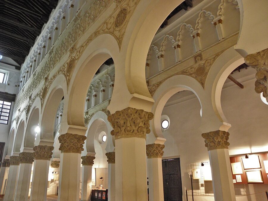 Interior of Sinagoga Santa Maria la Blanca with white columns and horseshoe arches