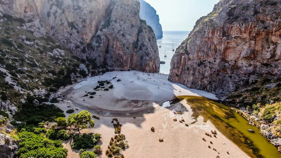 Aerial of Torrent de Pareis beach surrounded by cliffs in Mallorca