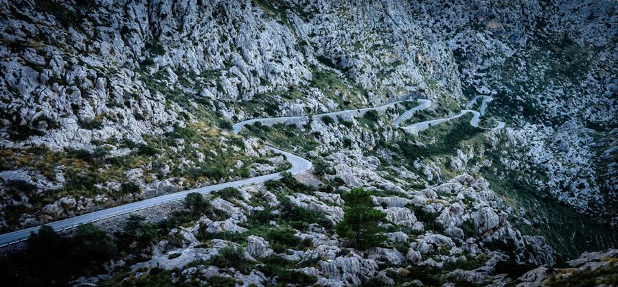 Aerial of winding road through Tramuntana mountains in Mallorca