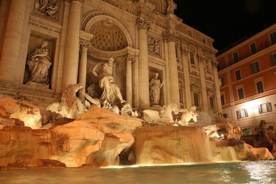 Trevi Fountain at night with water flowing Rome