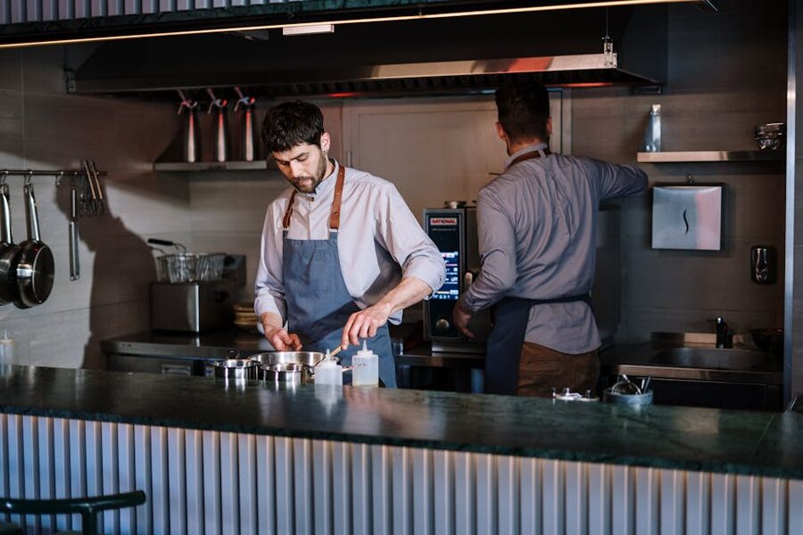 Chefs preparing ingredients in an open kitchen Barcelona class