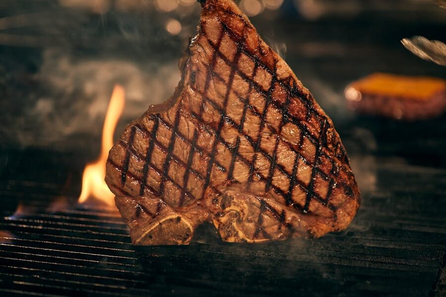 Txuleta T-bone steak grilled over flames Basque Country
