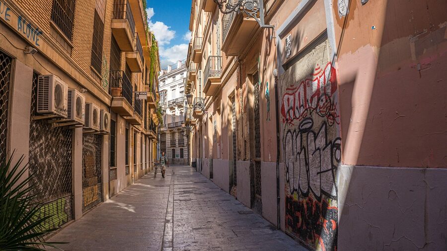 Narrow alley in Valencia old town under blue sky