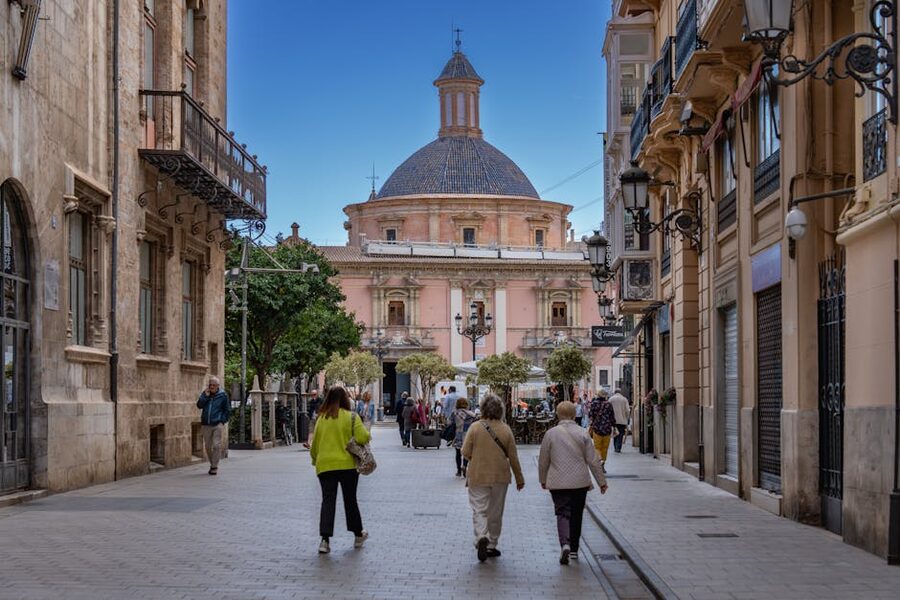 People walking on a historic street in Valencia old town