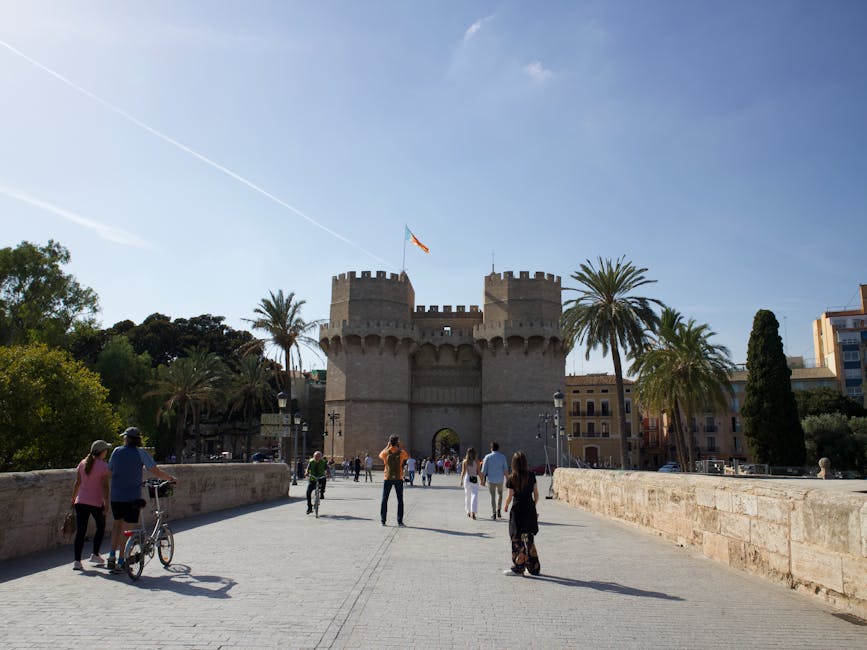 Tourists at Torres de Serranos Valencia under blue sky
