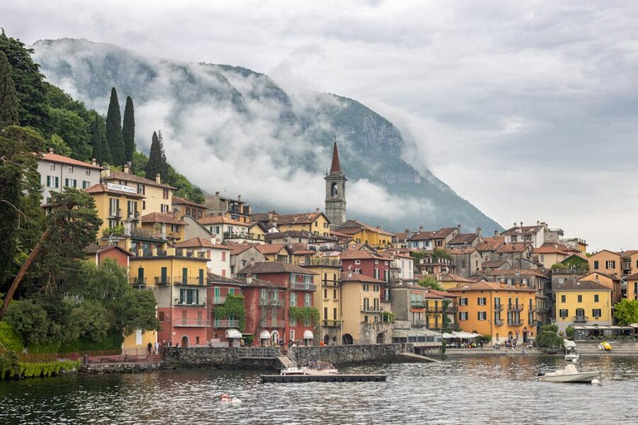 Varenna with colorful buildings and misty mountains on Lake Como