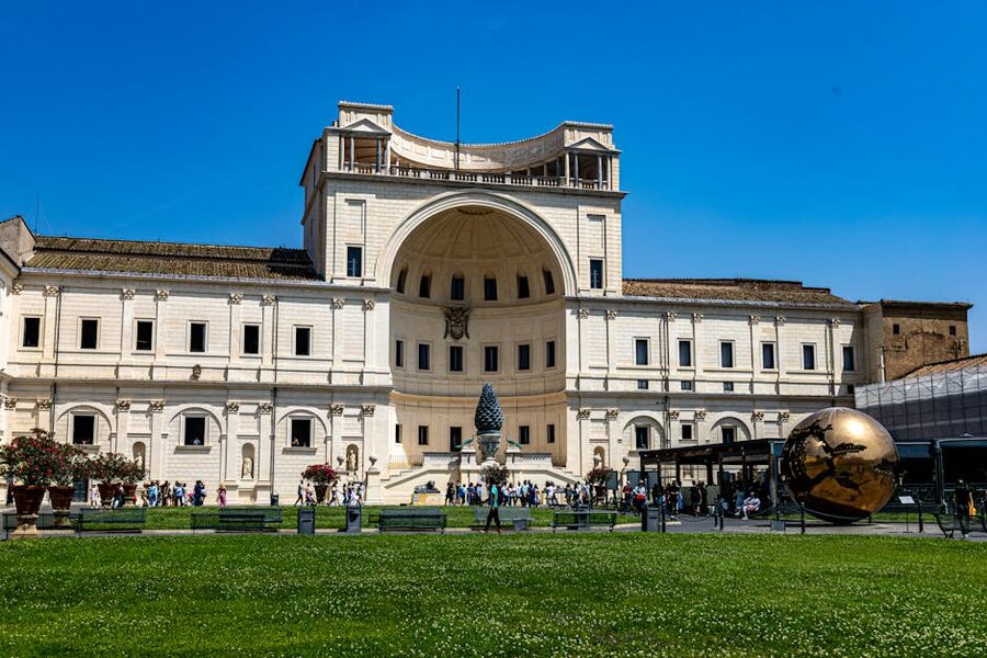 Crowds in the Vatican Museums courtyard on a sunny day