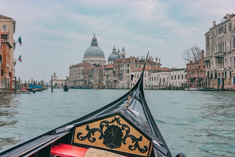 Gondola on the Grand Canal in Venice with church architecture behind