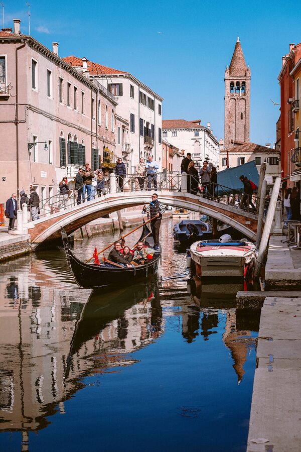 A gondola with several passengers seated together in Venice