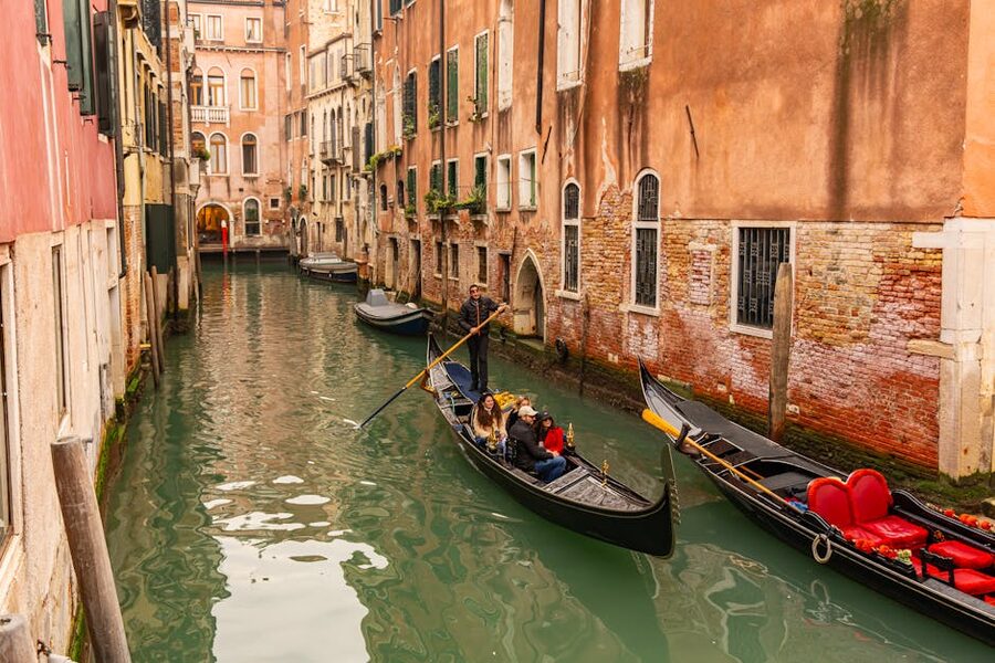 Two gondolas tied up on a quiet Venice neighbourhood canal