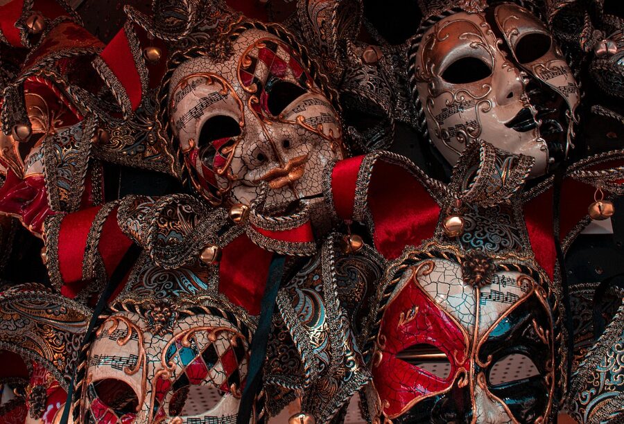 Golden Venetian carnival mask with feathers and ornate detail