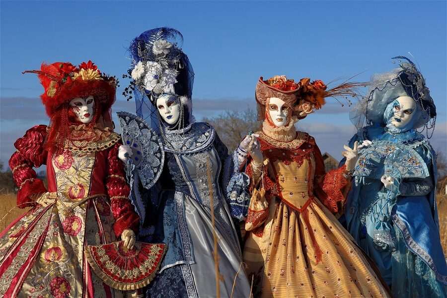 Costumed figures in Venice carnival headdresses and masks