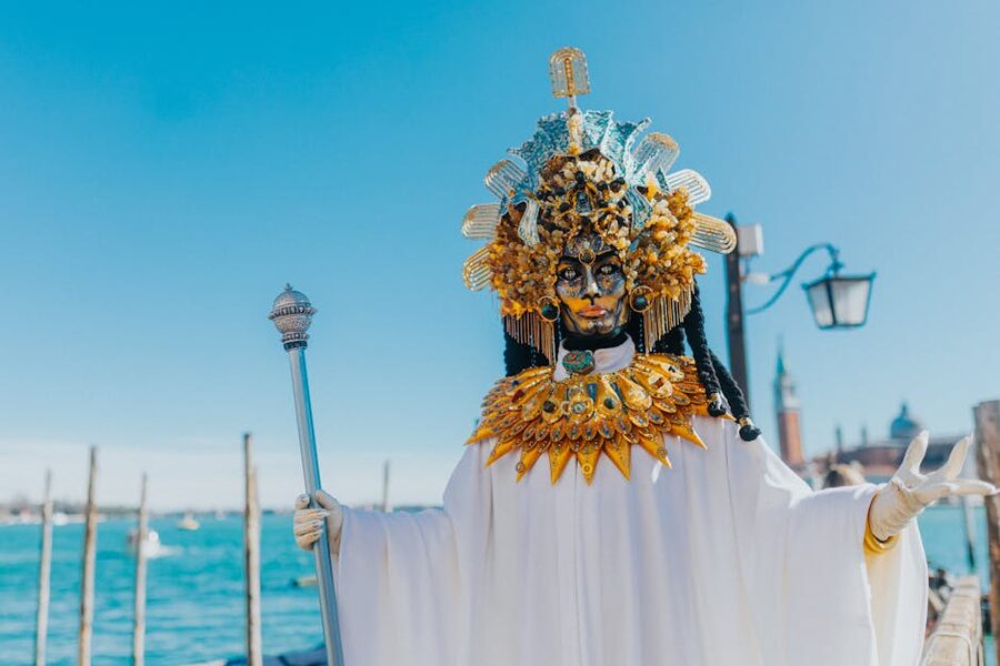 Costumed figure in Venetian carnival mask near St Marks Square