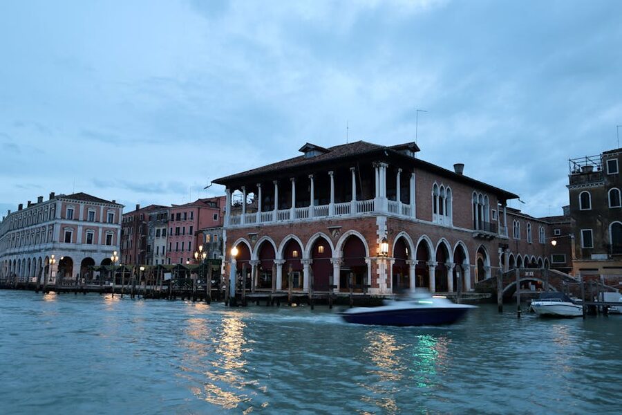 A Venice canal at blue hour with historic architecture