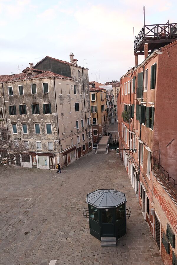A campo in the Jewish Ghetto of Venice with brick facades