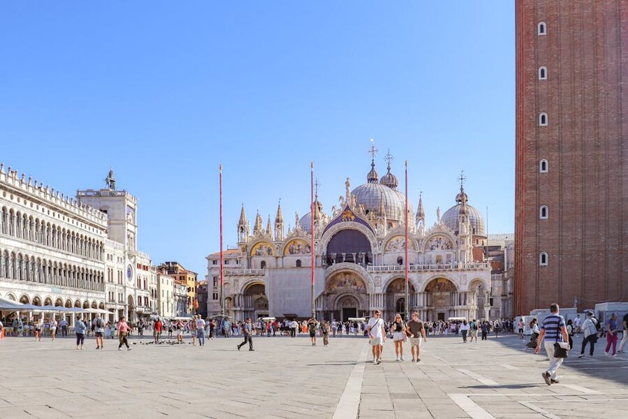 Tourists in St Mark's Square near the basilica on a sunny day