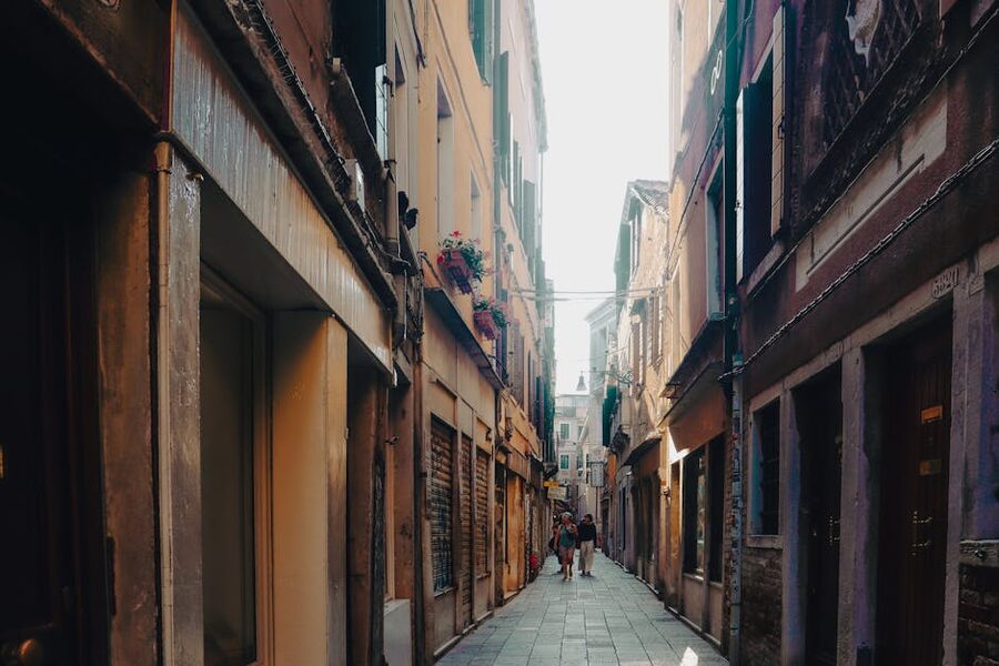 A sunlit Venetian alleyway with historic buildings